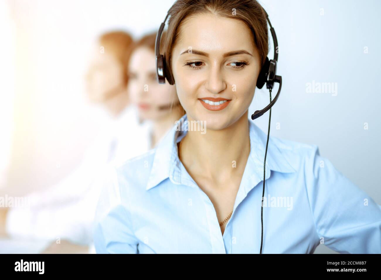 Call center. Focus on beautiful business woman in headset Stock Photo ...