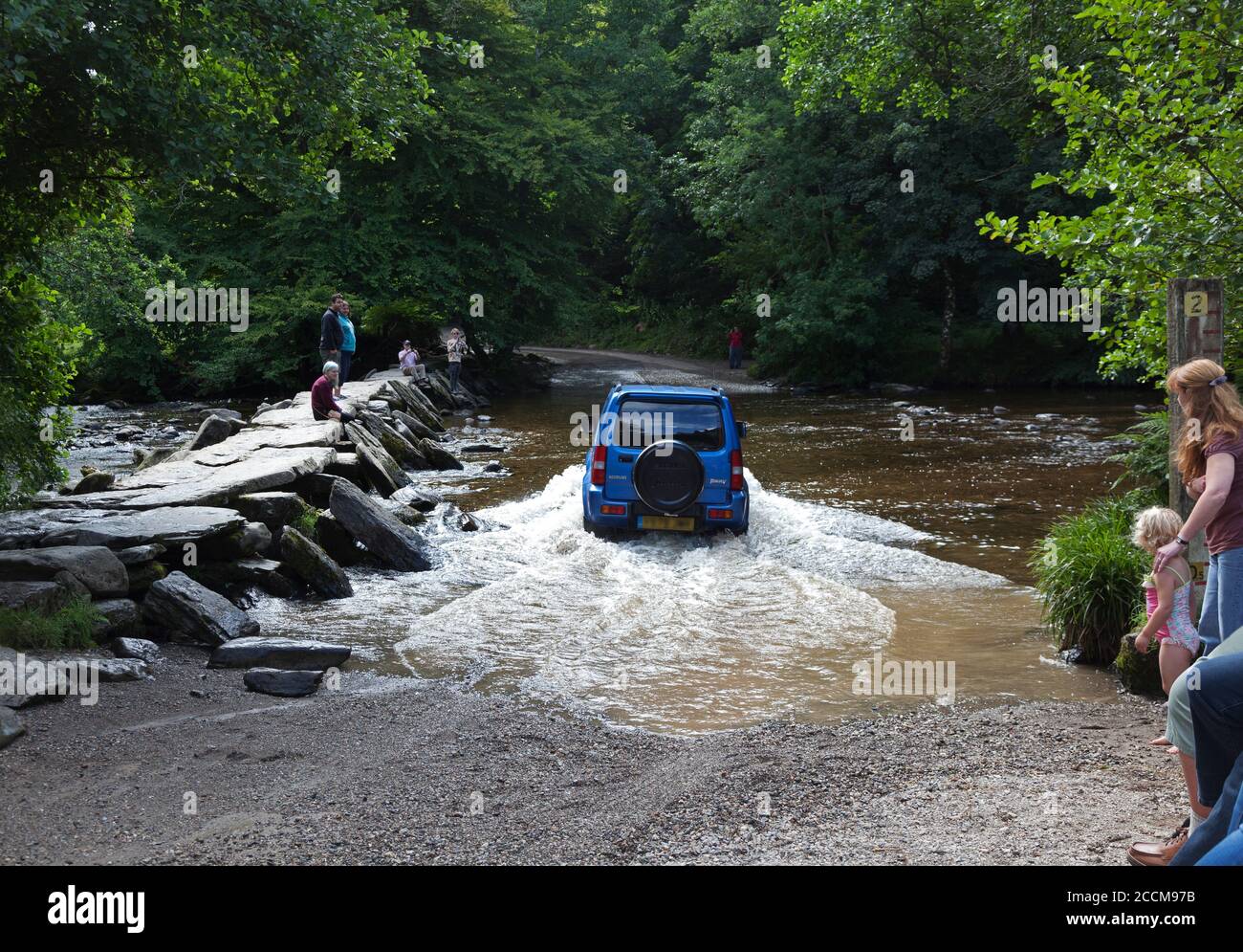 A car drives through the River Barle at the clapper bridge known as ...