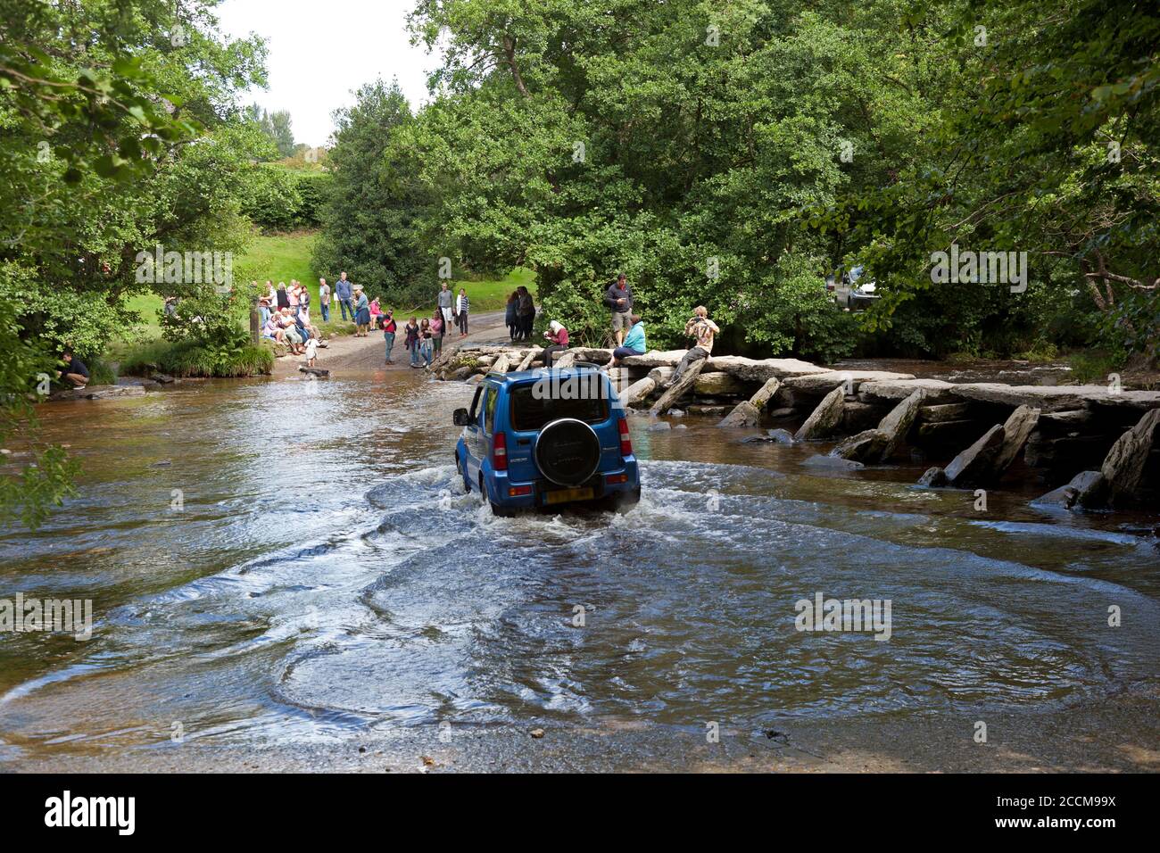 A car drives through the River Barle at the clapper bridge known as ...