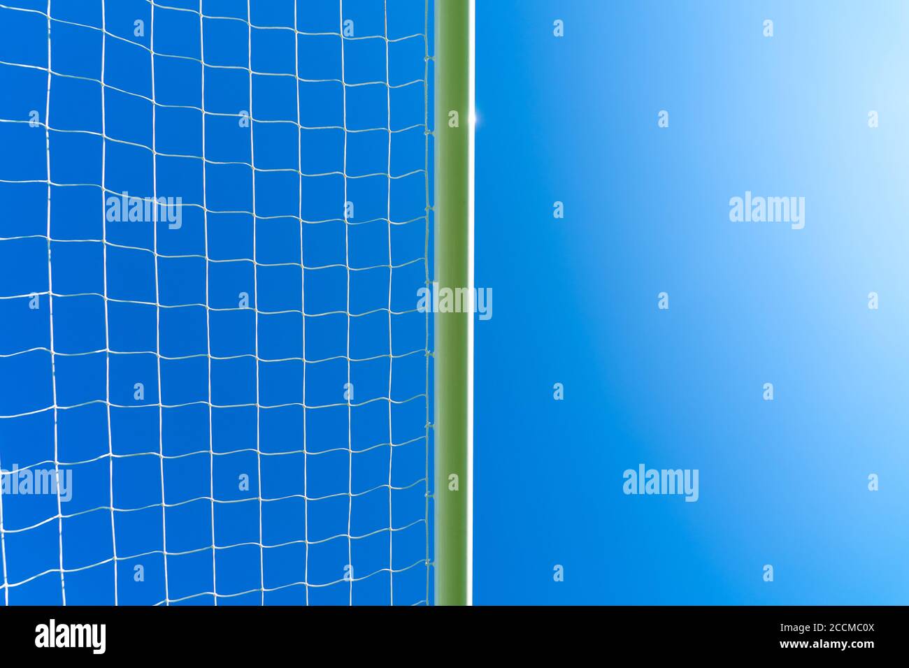 Soccer football goalpost and net with blue sky and white clouds ...