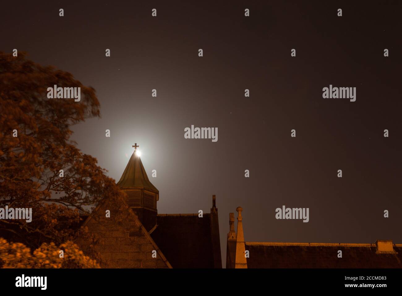 Moonlight on a church roof with glow of sodium street lights Stock ...
