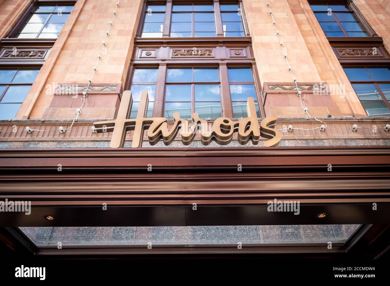 London- Harrods building exterior sign, a landmark shopping destination ...
