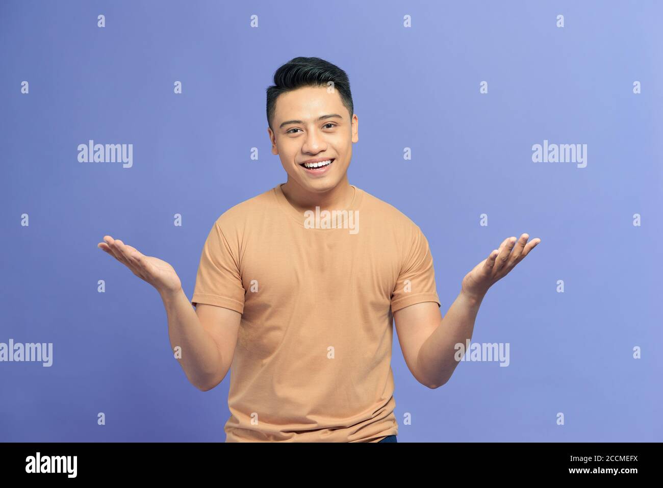 Smiling man standing with open arms, welcome gesture Stock Photo - Alamy