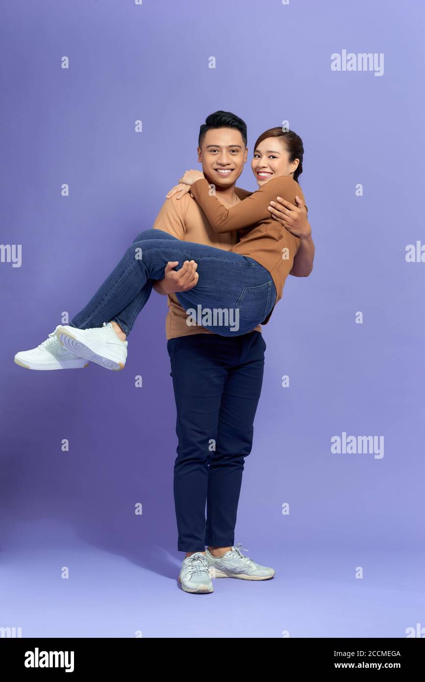Man holding woman on hands Stock Photo - Alamy