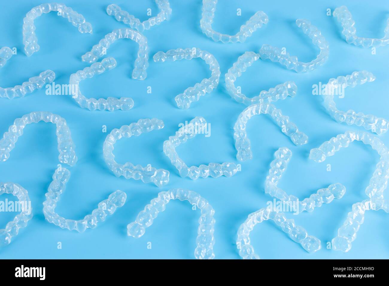 Invisalign transparent brackets on blue background pattern Stock Photo ...