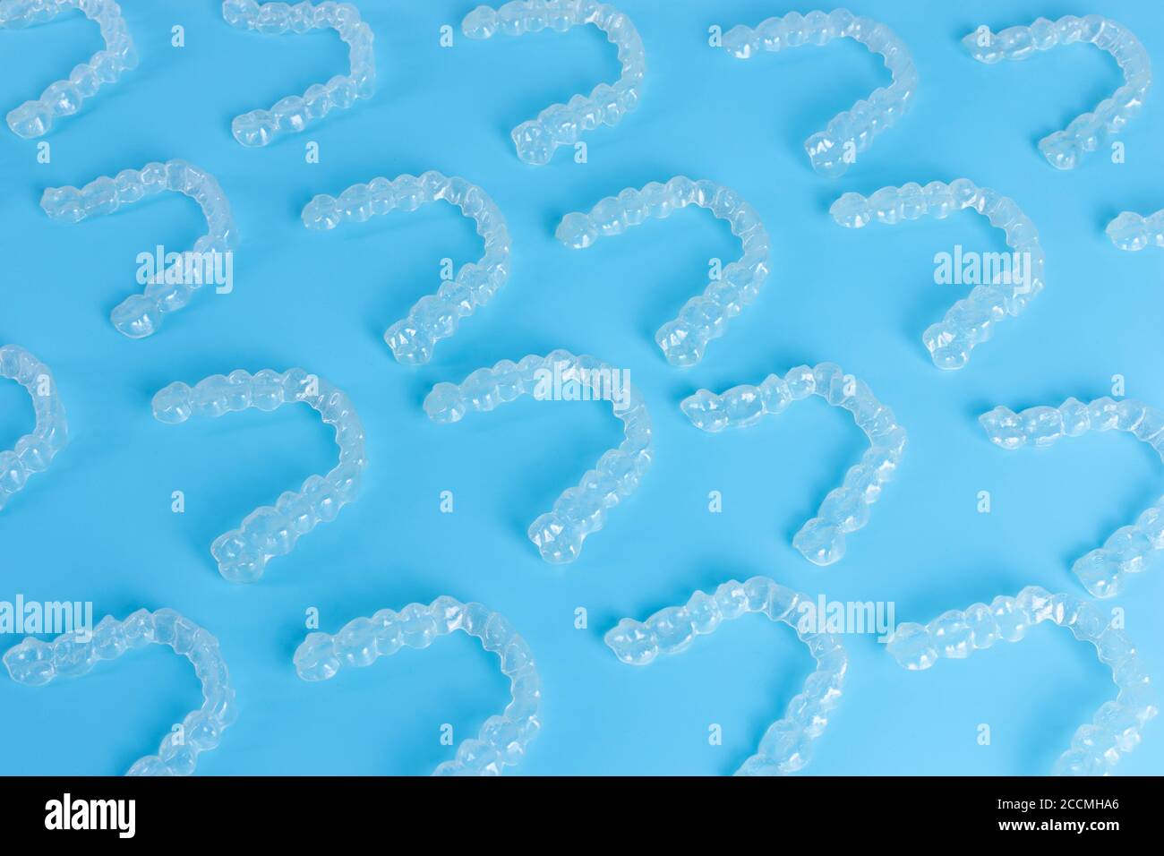Many invisalign transparent brackets pattern on blue background Stock ...