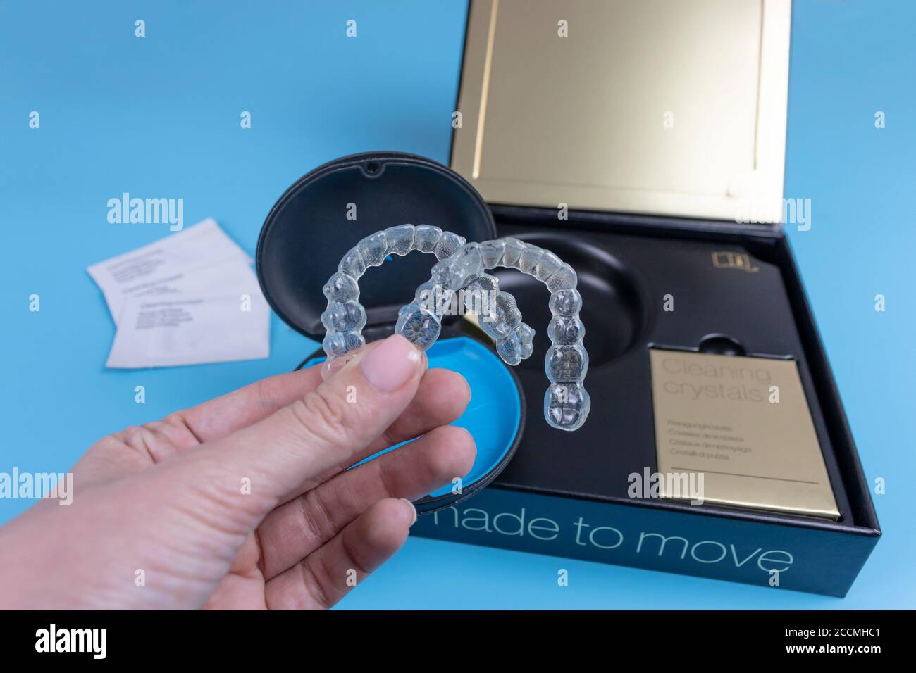 Invisalign transparent brackets package box on blue background and ...