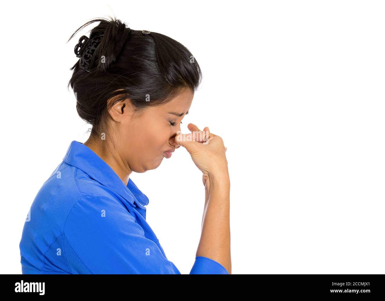 Closeup portrait of a young woman with disgust on face, pinches nose ...