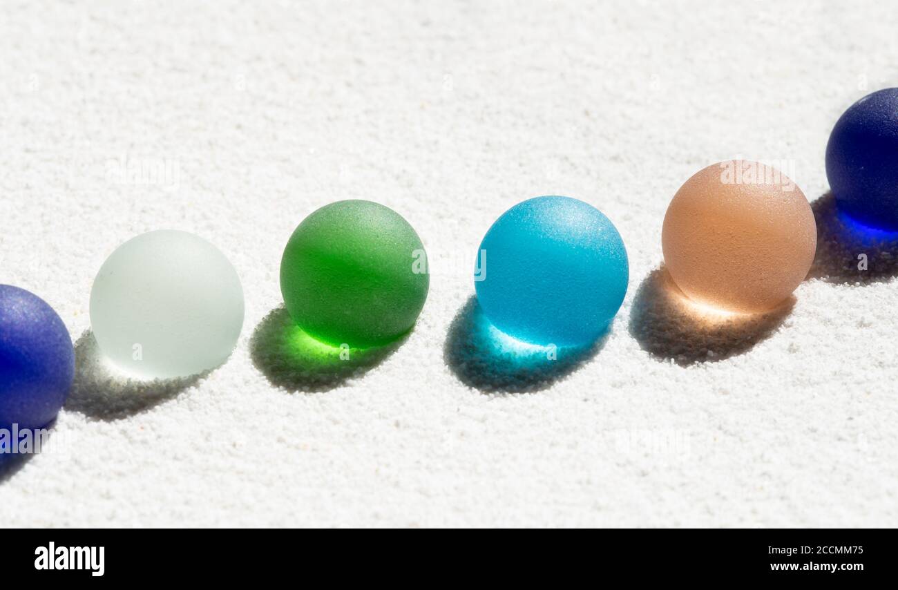 Glass marbles on sand hi-res stock photography and images - Alamy