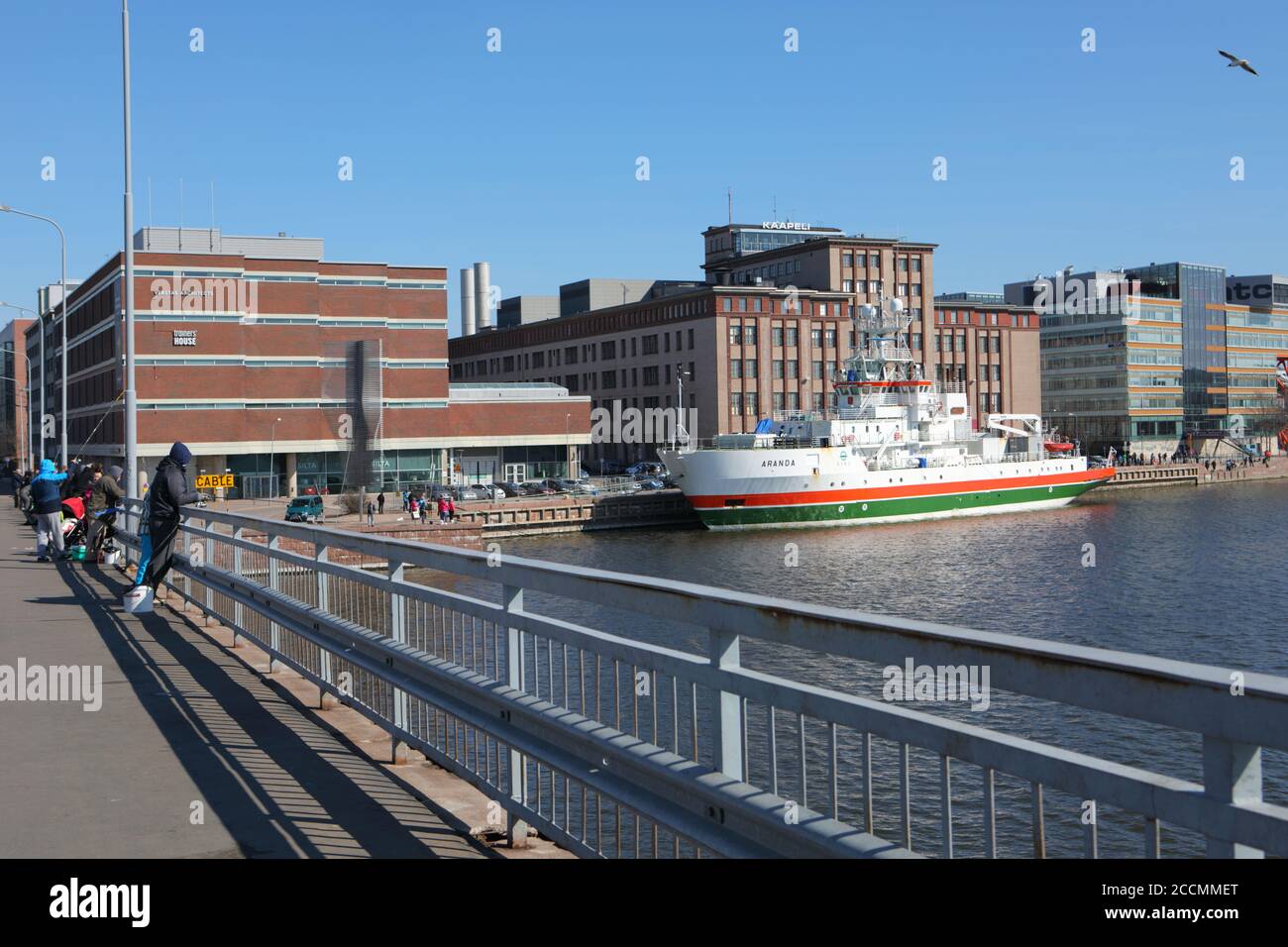 Nautical vessel with orange and green stripes moored at Salmisaari ...