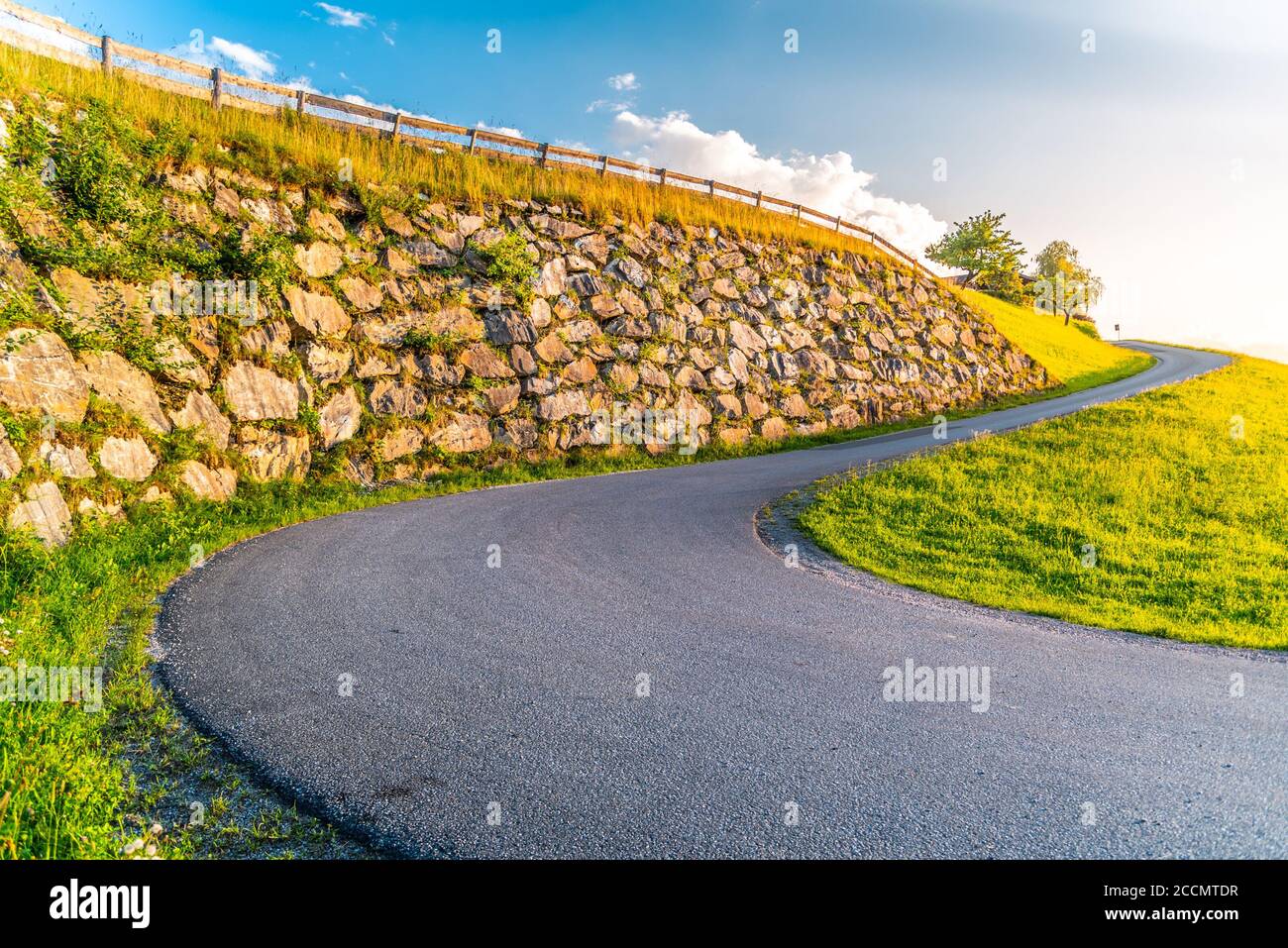 Sharp hairpin curve of narrow rural asphalt road in the mountains ...