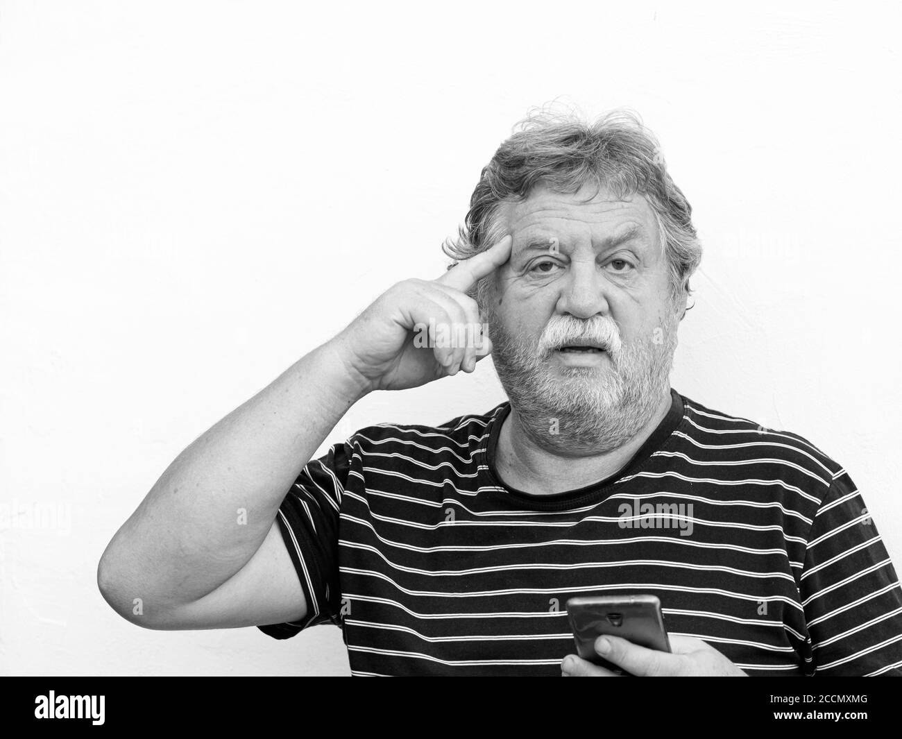 Black and white portrait of middle-aged man holds a finger of his right ...