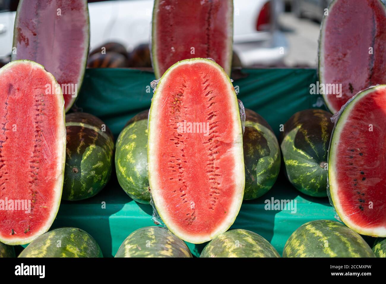 Closeup of fresh watermelons on display in a market during daylight ...
