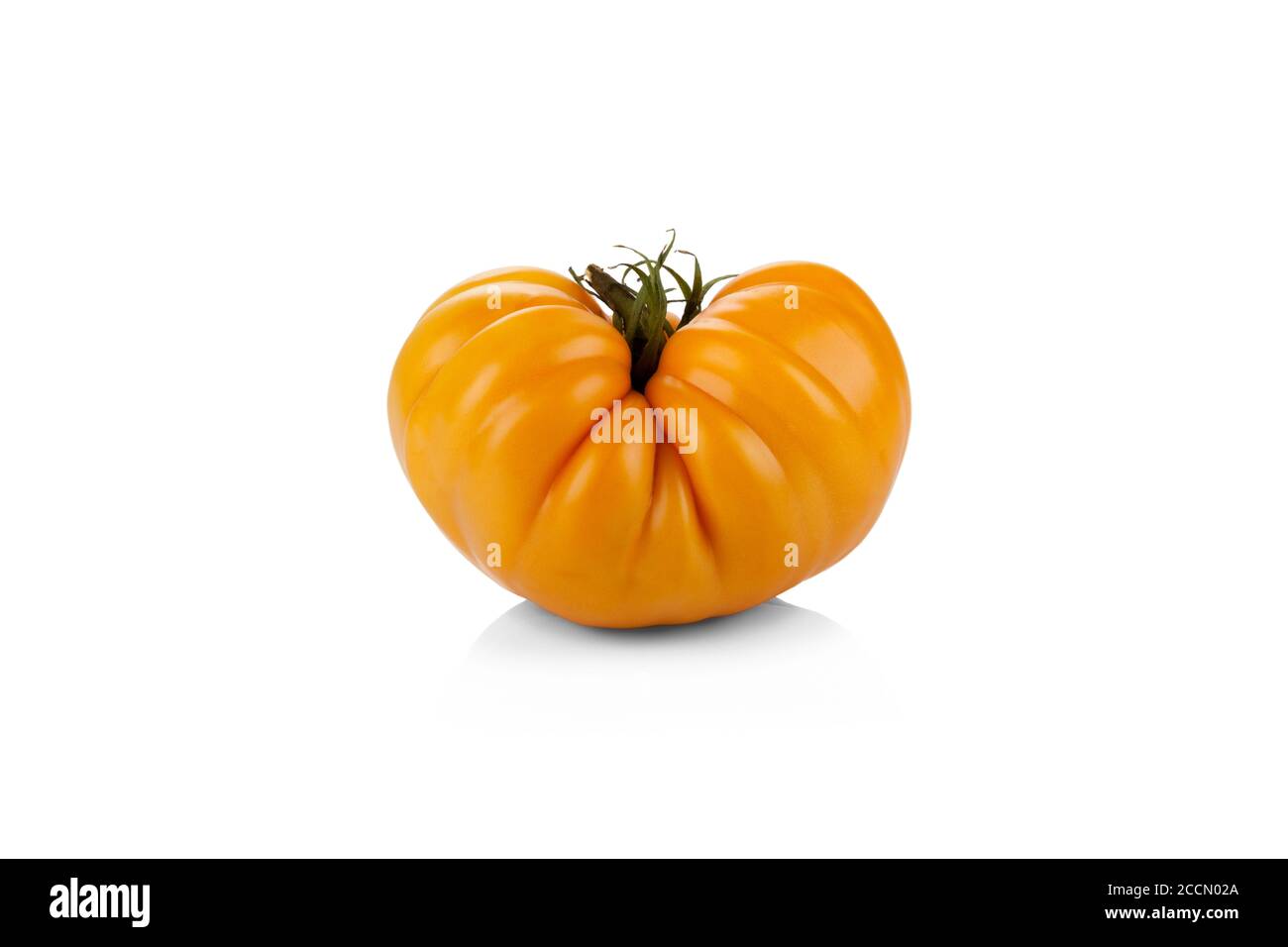 Large yellow tomato in the shape of heart isolated on white background ...