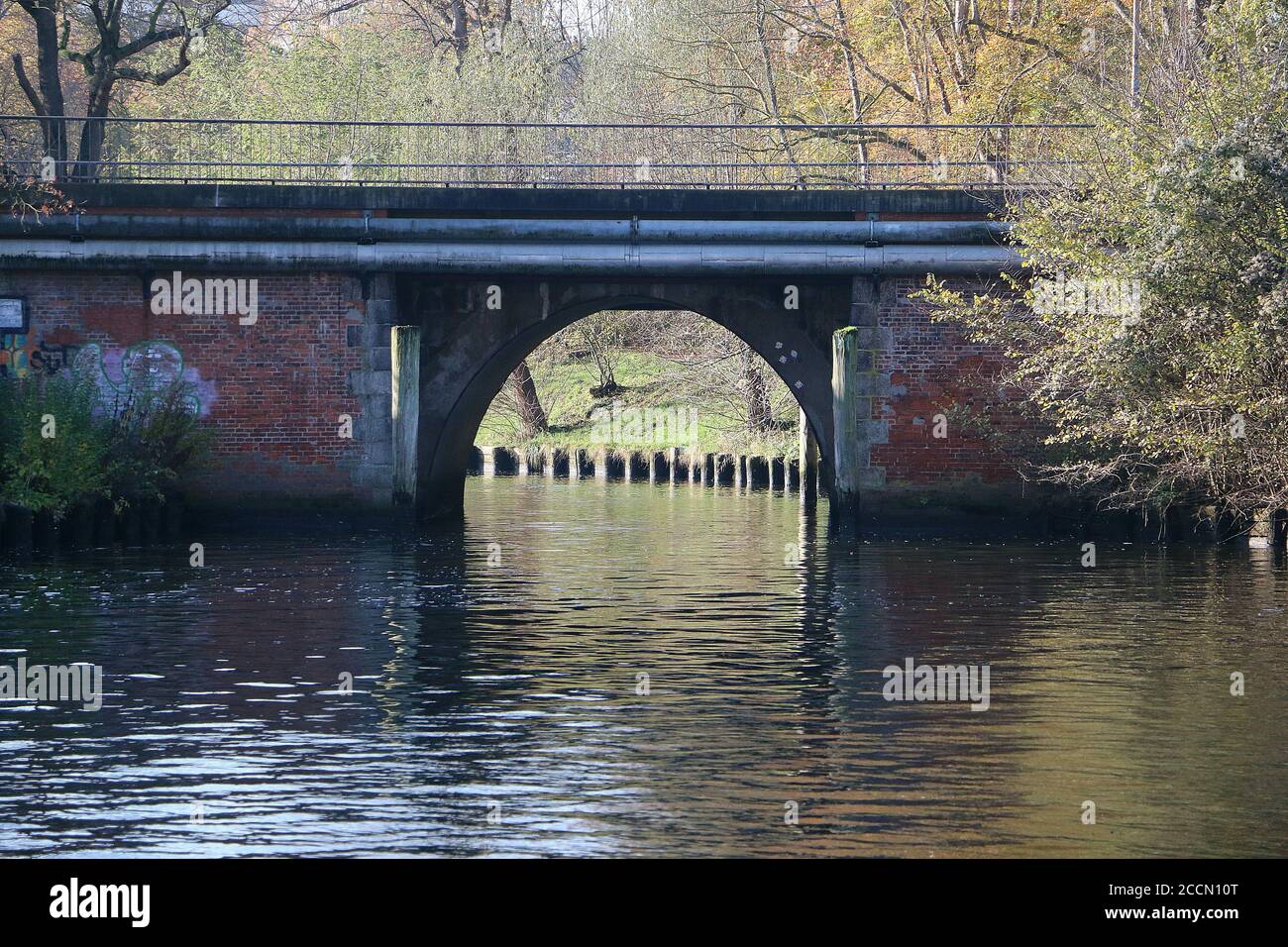 Small brick bridge with an arch over a river in a park Stock Photo - Alamy