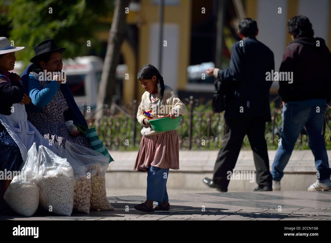 A young girl selling candy in the town square in Potosi, Bolivia Stock ...