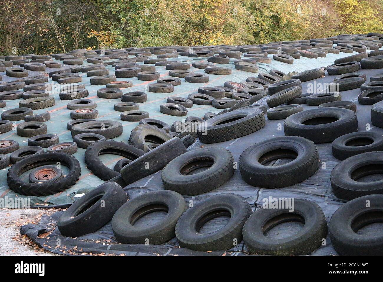 Bunch of tires organized in rows in a park Stock Photo - Alamy