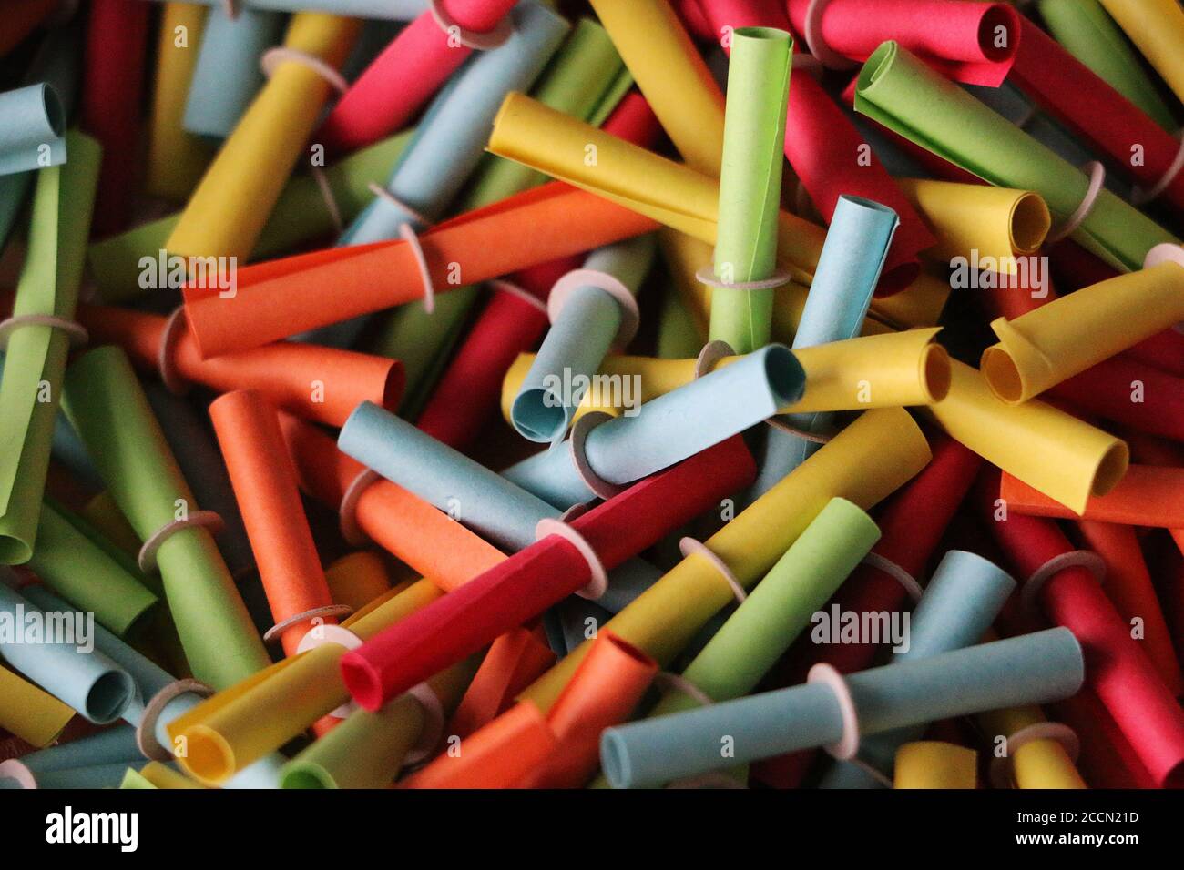 Top view of bright colorful rolled up papers Stock Photo - Alamy