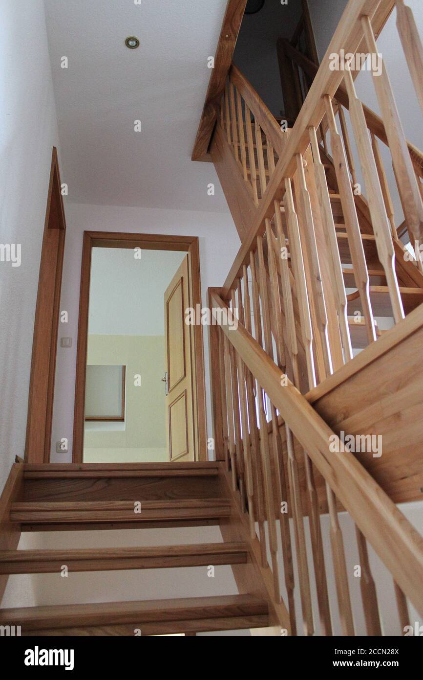 Vertical shot of wooden stairs and doors inside a class home Stock ...