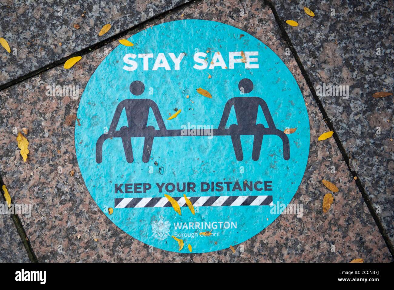 Keep your distance sticker on Warrington high street Stock Photo - Alamy