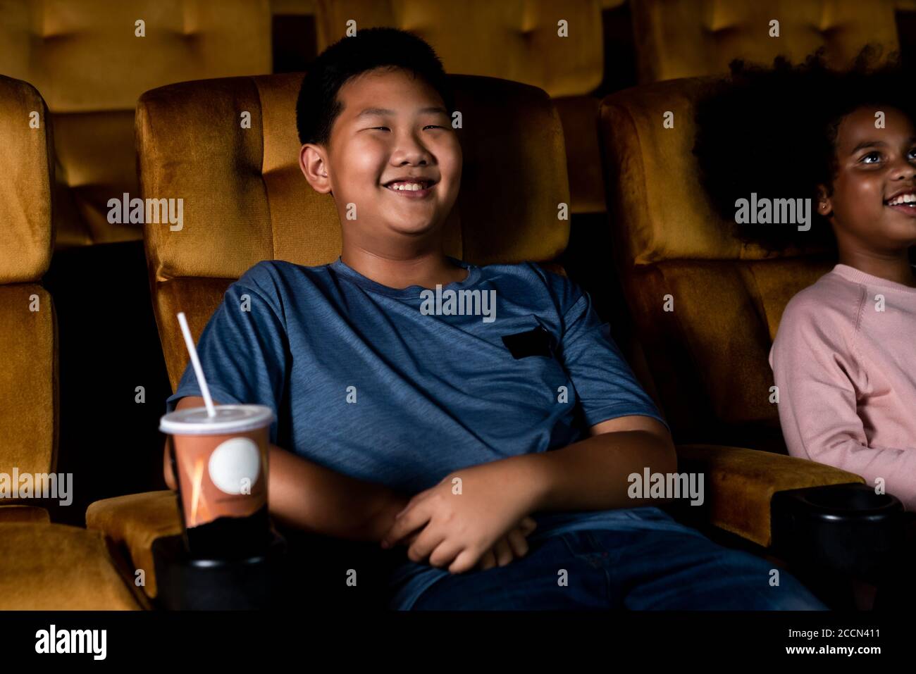 Two children watching cartoon movie hi-res stock photography and images ...