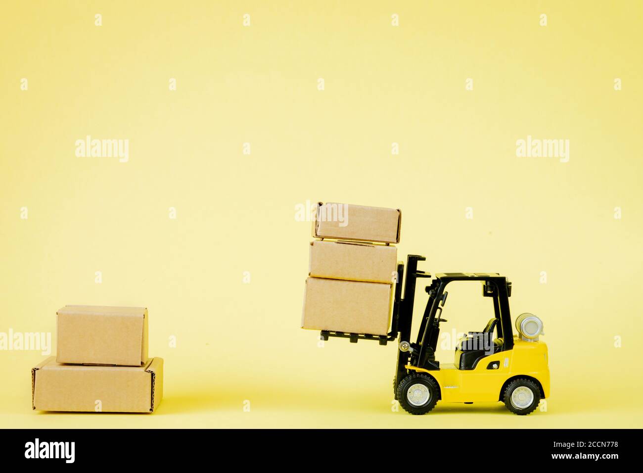 Mini forklift truck load cardboard boxes. Logistics and transportation ...