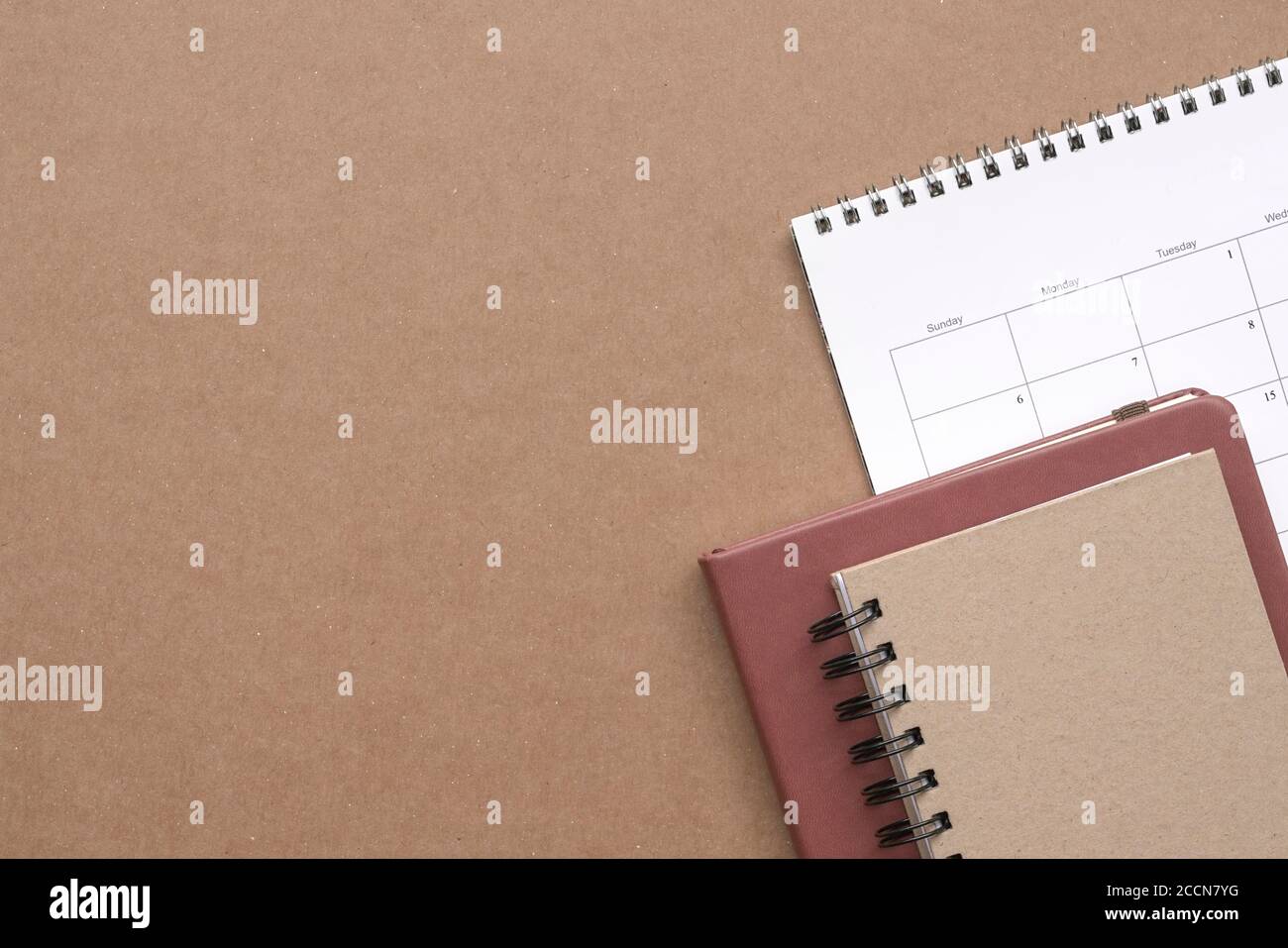 Notebooks and calendar on brown color table. Top view. Copy space Stock ...