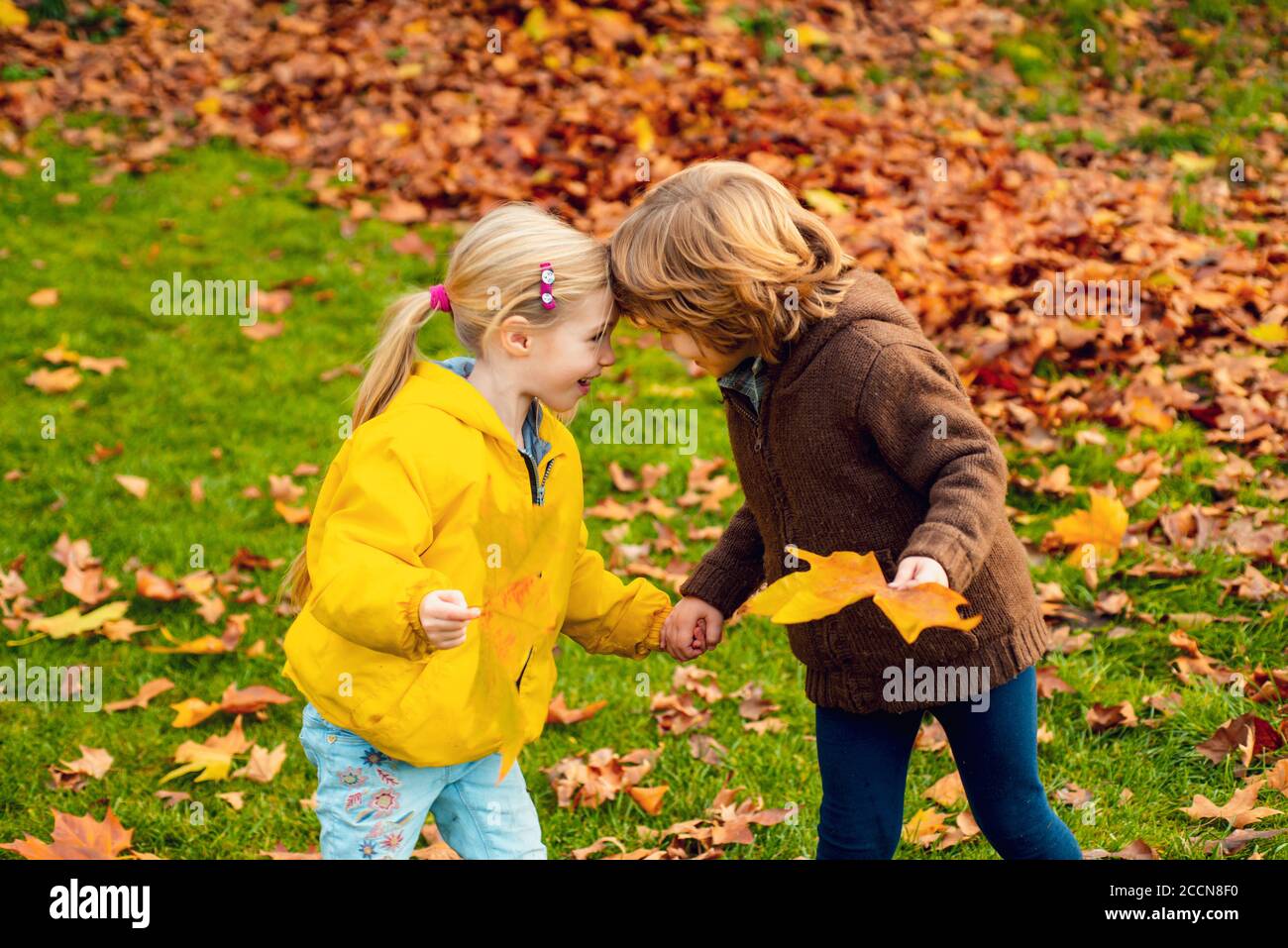 Two cheerful siblings brother and sister hugging each other and ...
