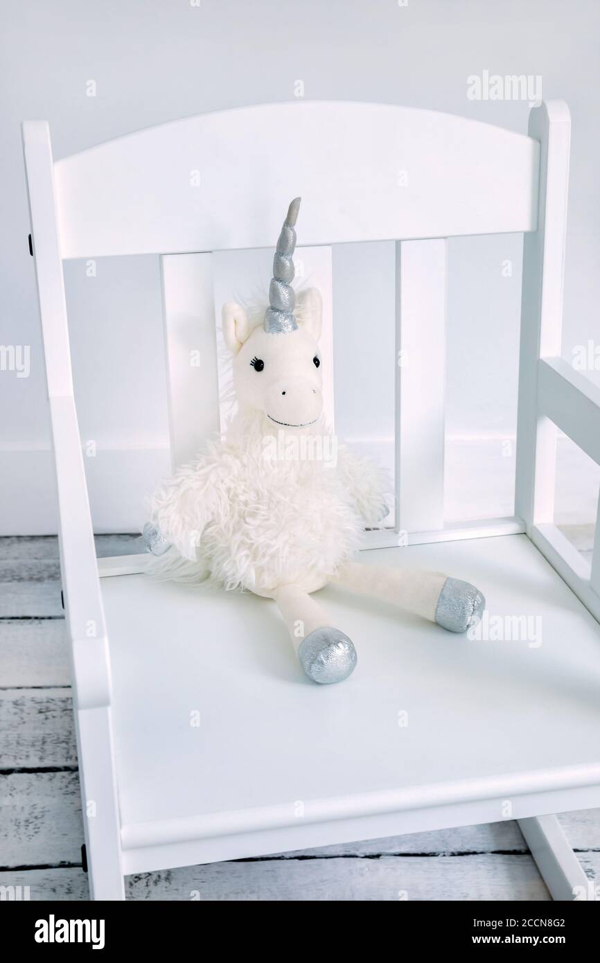 Plush unicorn toy on a child's rocking chair Stock Photo - Alamy