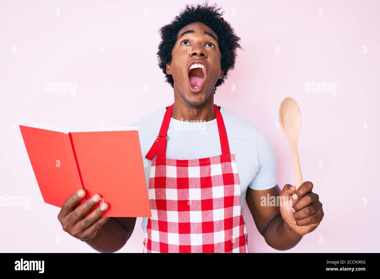 Handsome african american man with afro hair wearing professional baker ...