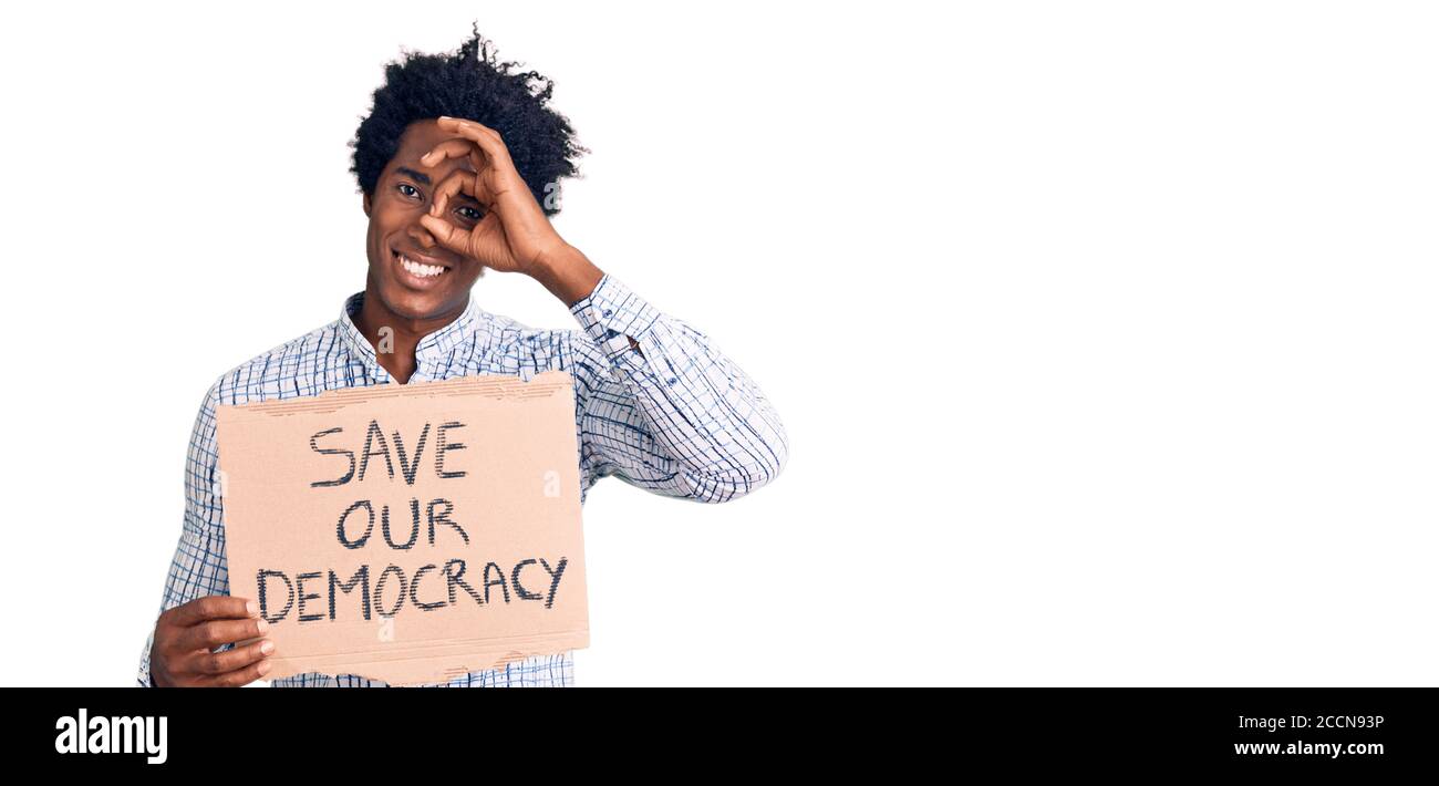 Handsome african american man with afro hair holding save our democracy ...
