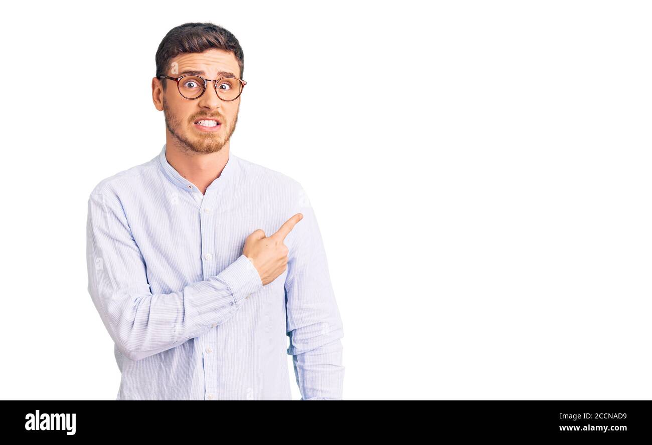 Handsome young man with bear wearing elegant business shirt and glasses ...
