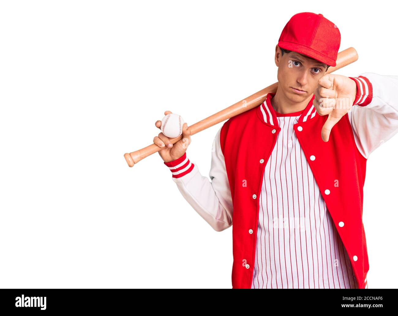 Young handsome man playing baseball holding bat and ball with angry ...