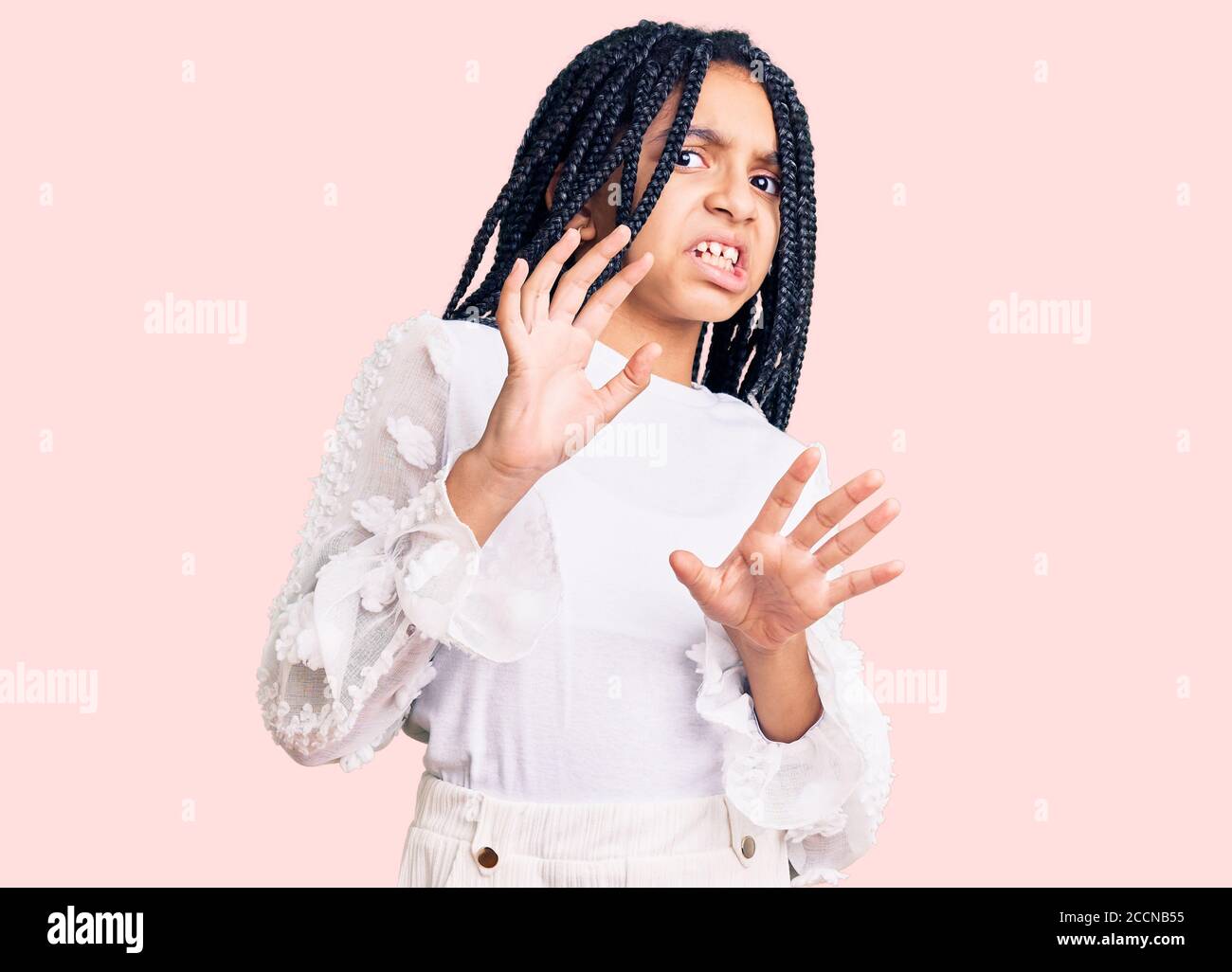 Cute african american girl wearing casual white tshirt disgusted ...