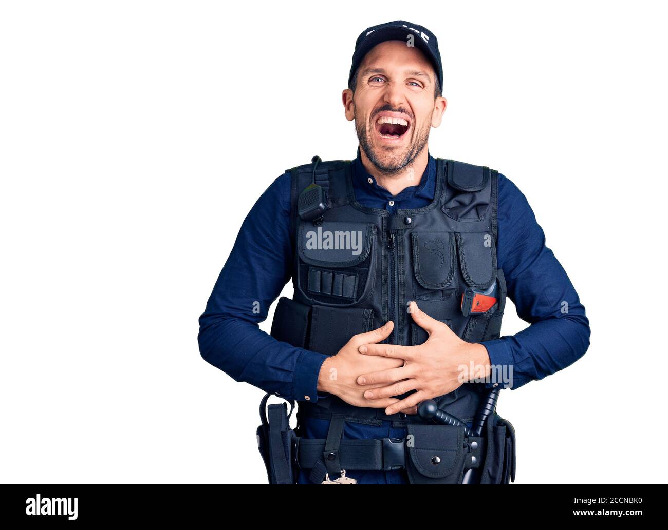 Young handsome man wearing police uniform smiling and laughing hard out ...