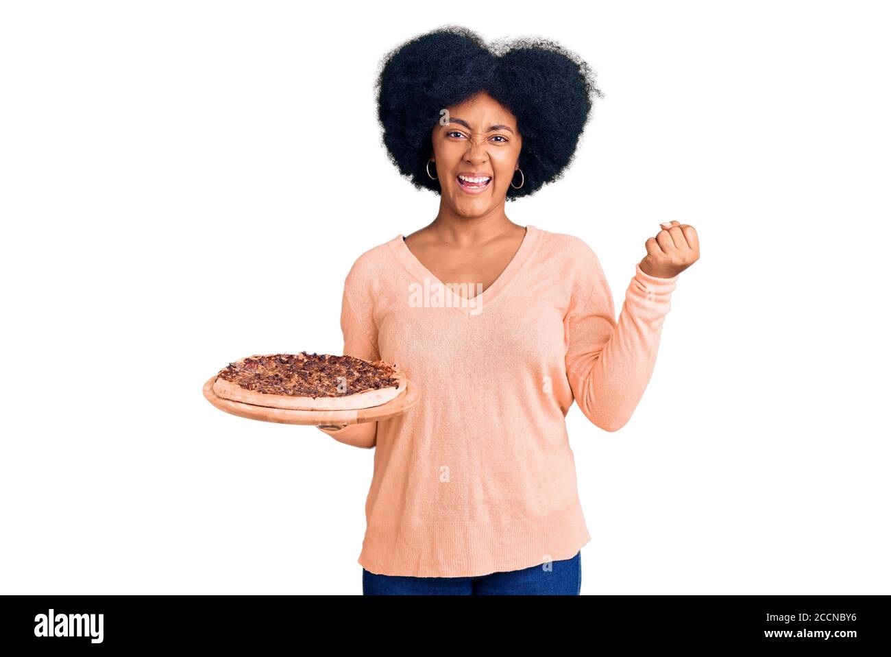 Young african american girl holding italian pizza screaming proud ...