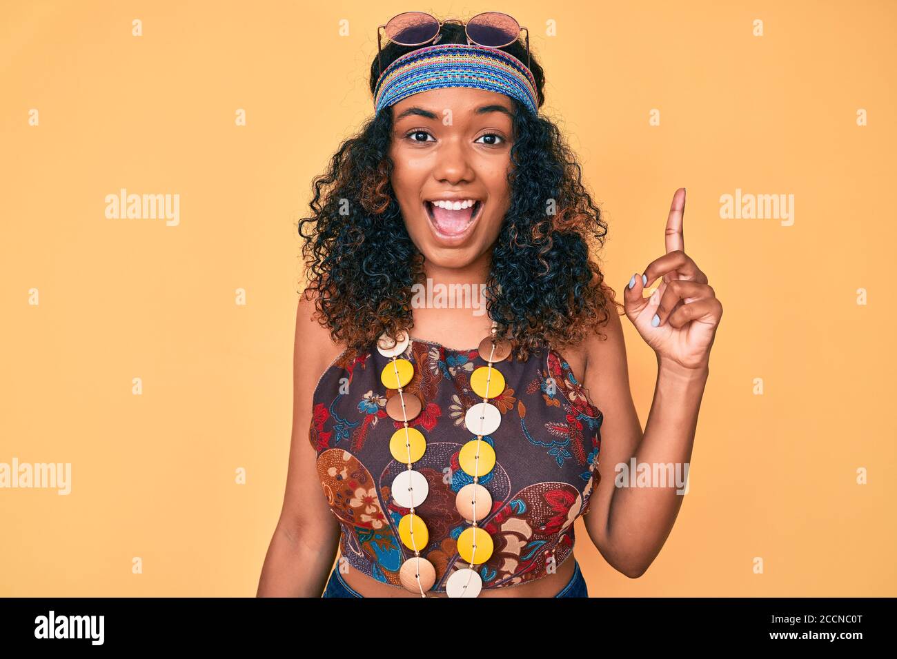 Young african american woman wearing bohemian and hippie style pointing ...