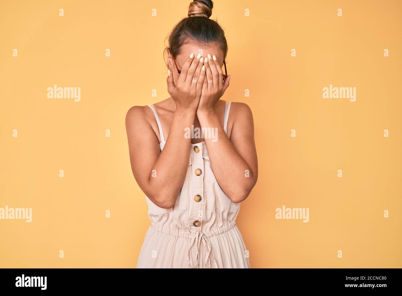 Beautiful caucasian woman wearing summer dress with sad expression ...