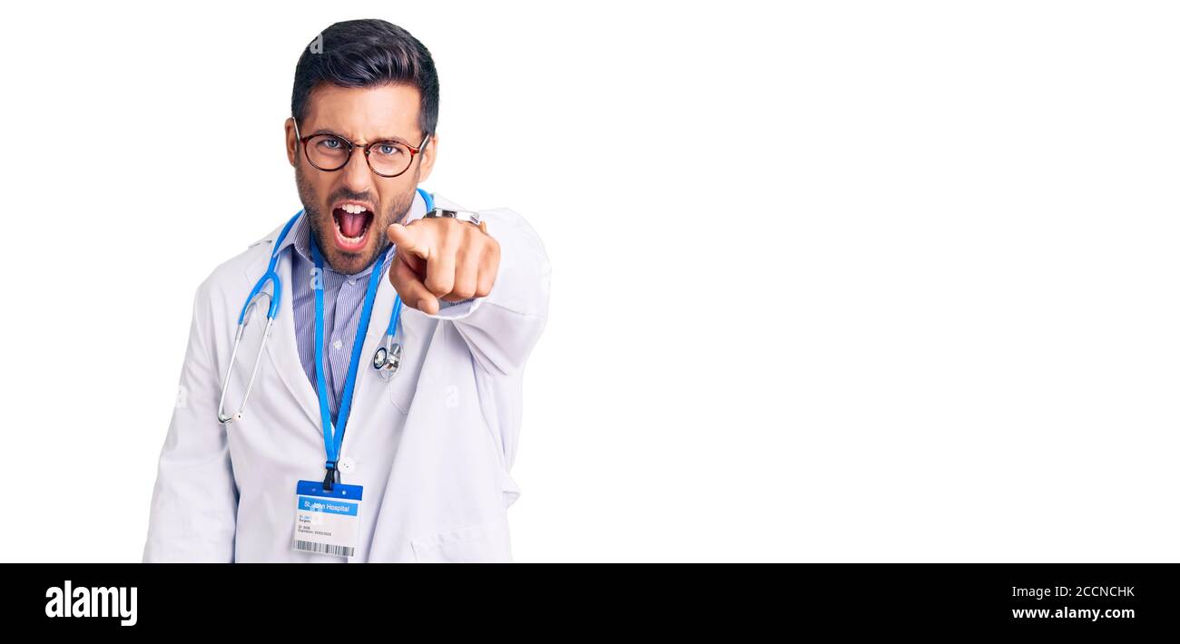 Young hispanic man wearing doctor uniform and stethoscope pointing ...