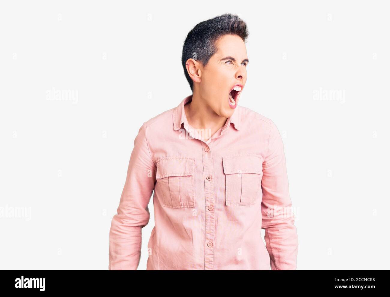 Young woman with short hair wearing casual clothes angry and mad ...