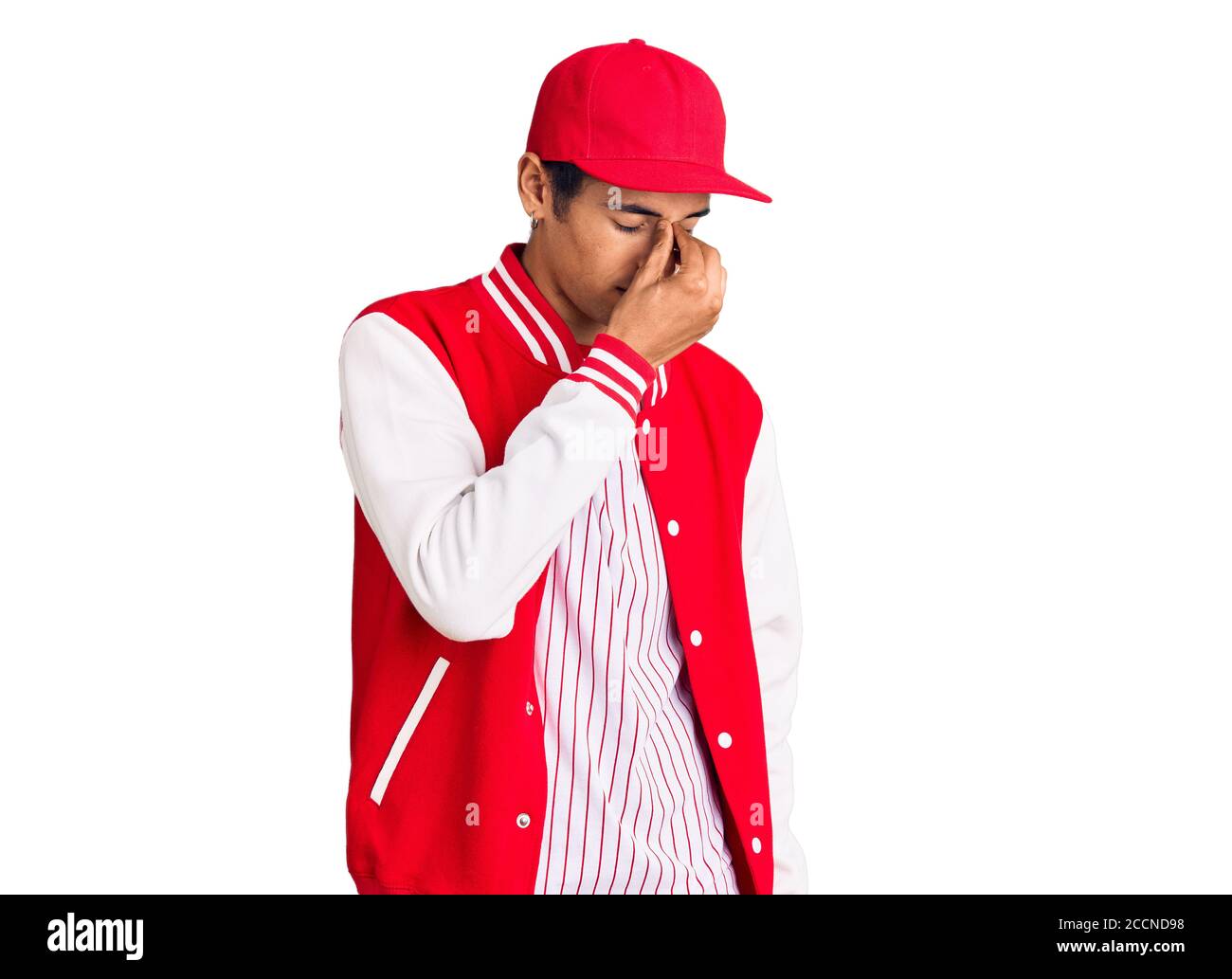 Young african amercian man wearing baseball uniform tired rubbing nose ...