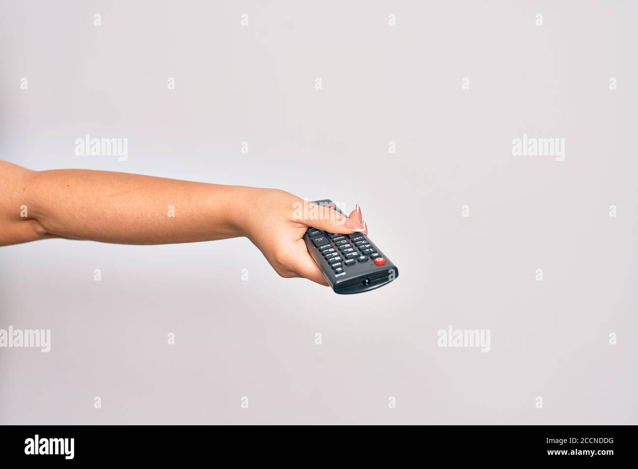 Hand of caucasian young woman changing television channel holding tv ...