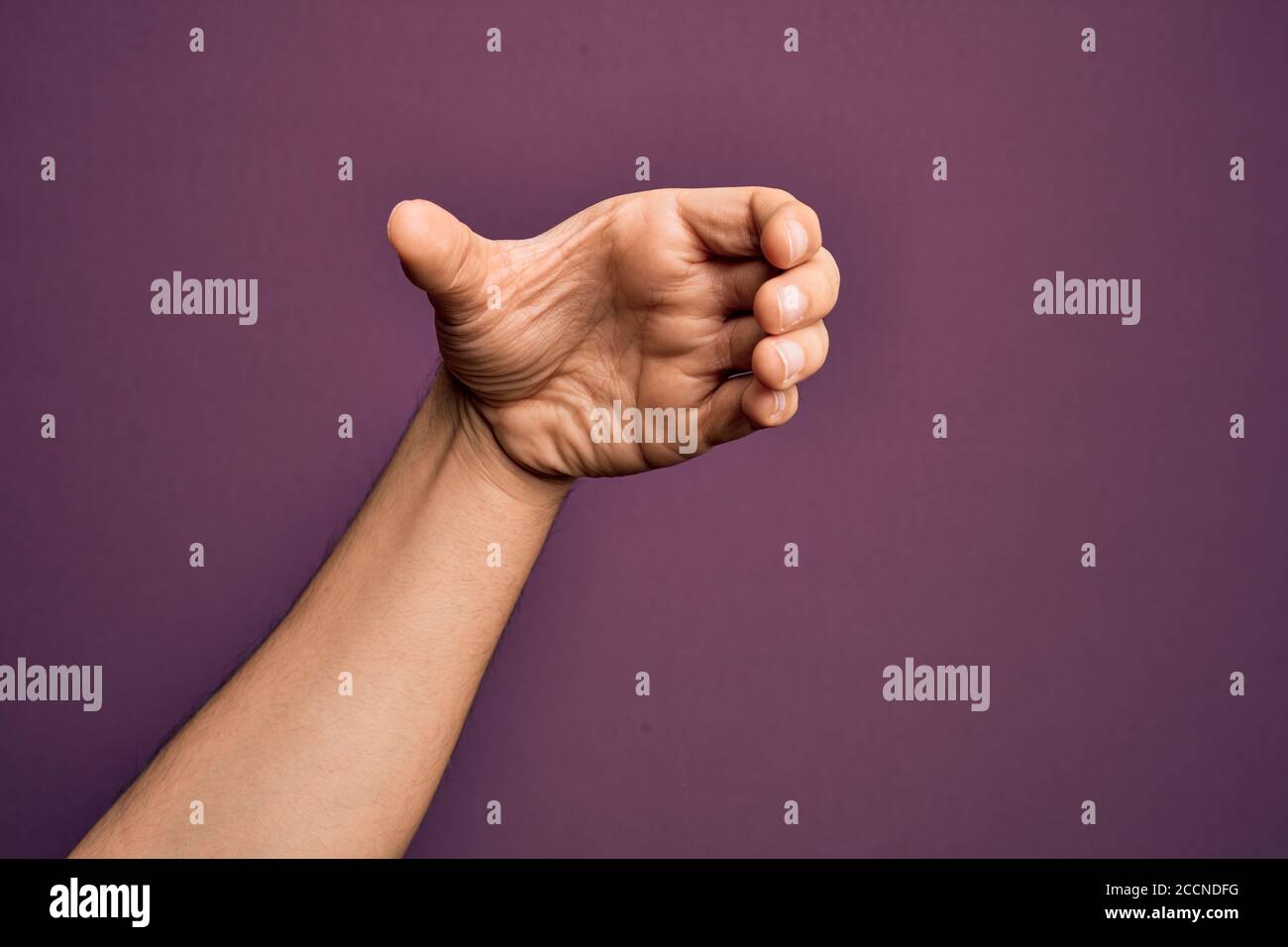 Hand of caucasian young man showing fingers over isolated purple ...