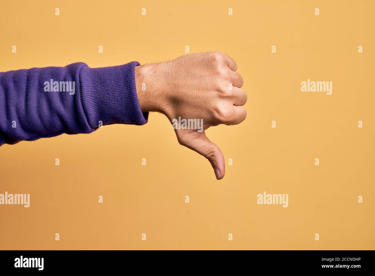 Hand of caucasian young man showing fingers over isolated yellow ...