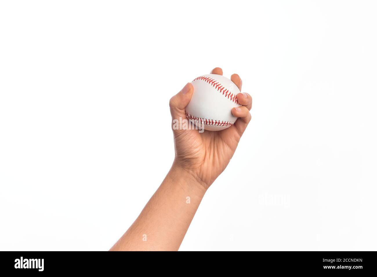 Hand of caucasian young man holding baseball ball over isolated white ...