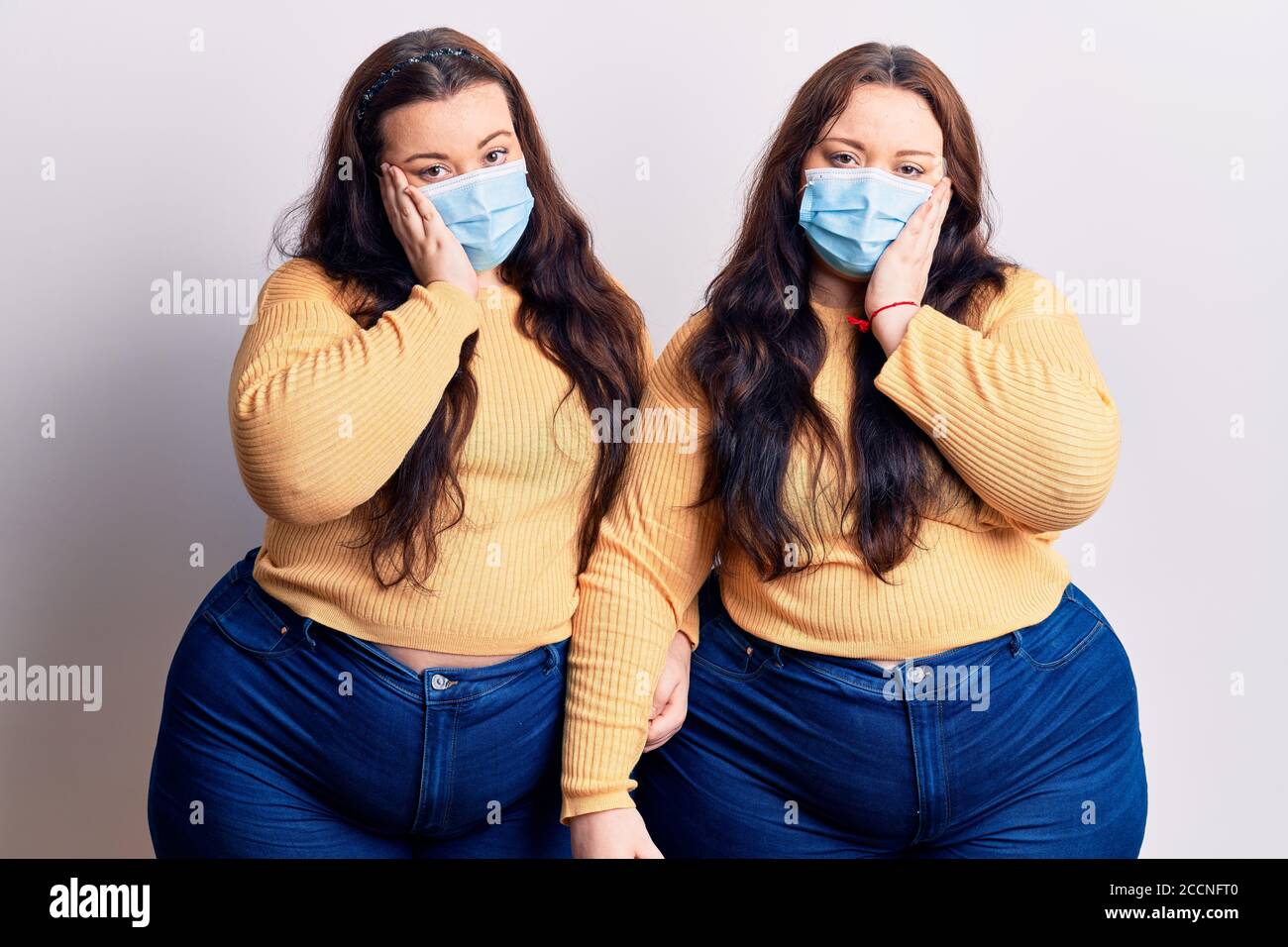 Twins arms crossed hi-res stock photography and images - Alamy