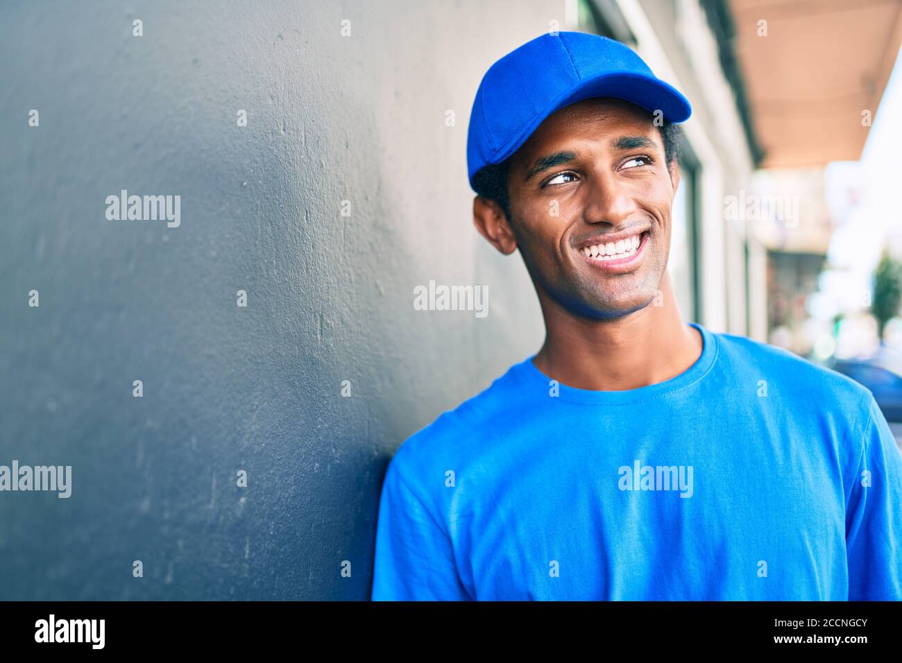 African delivery man wearing courier uniform outdoors Stock Photo - Alamy