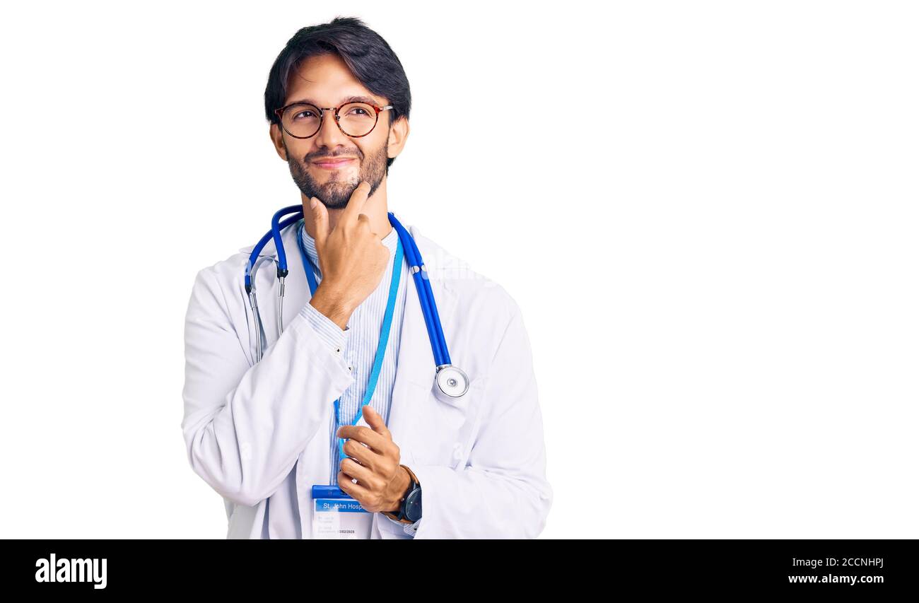 Handsome hispanic man wearing doctor uniform and stethoscope serious ...