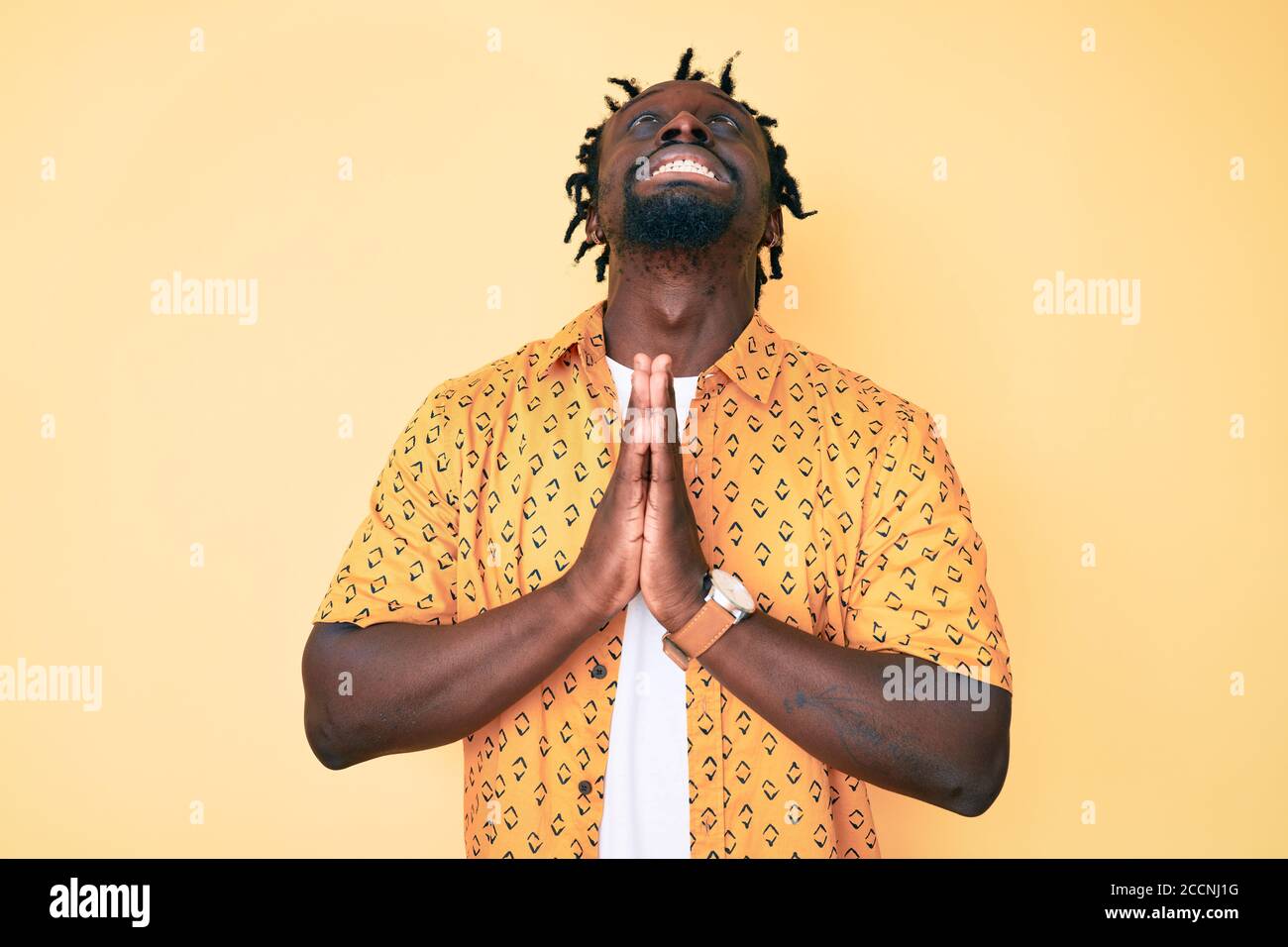 Young african american man with braids wearing casual clothes begging ...