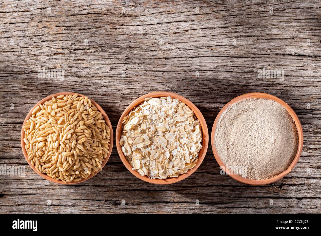 oat grains, flakes and flour on wood background Stock Photo - Alamy